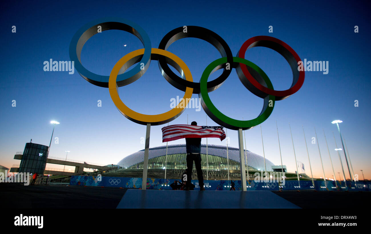 A Spectator poses with the US american flag in front of the the Olympic ...