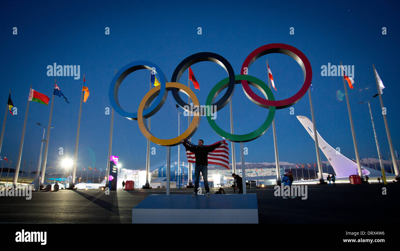 A Spectator poses with the US american flag in front of the the Olympic ...