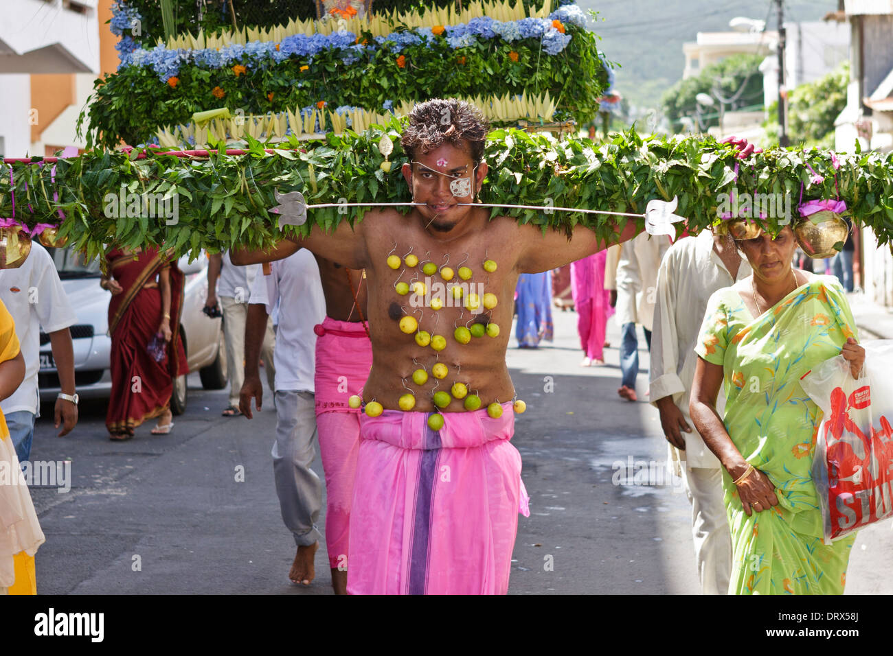A devotee of Lord Muruga carrying the Cavadee with his cheeks and ...