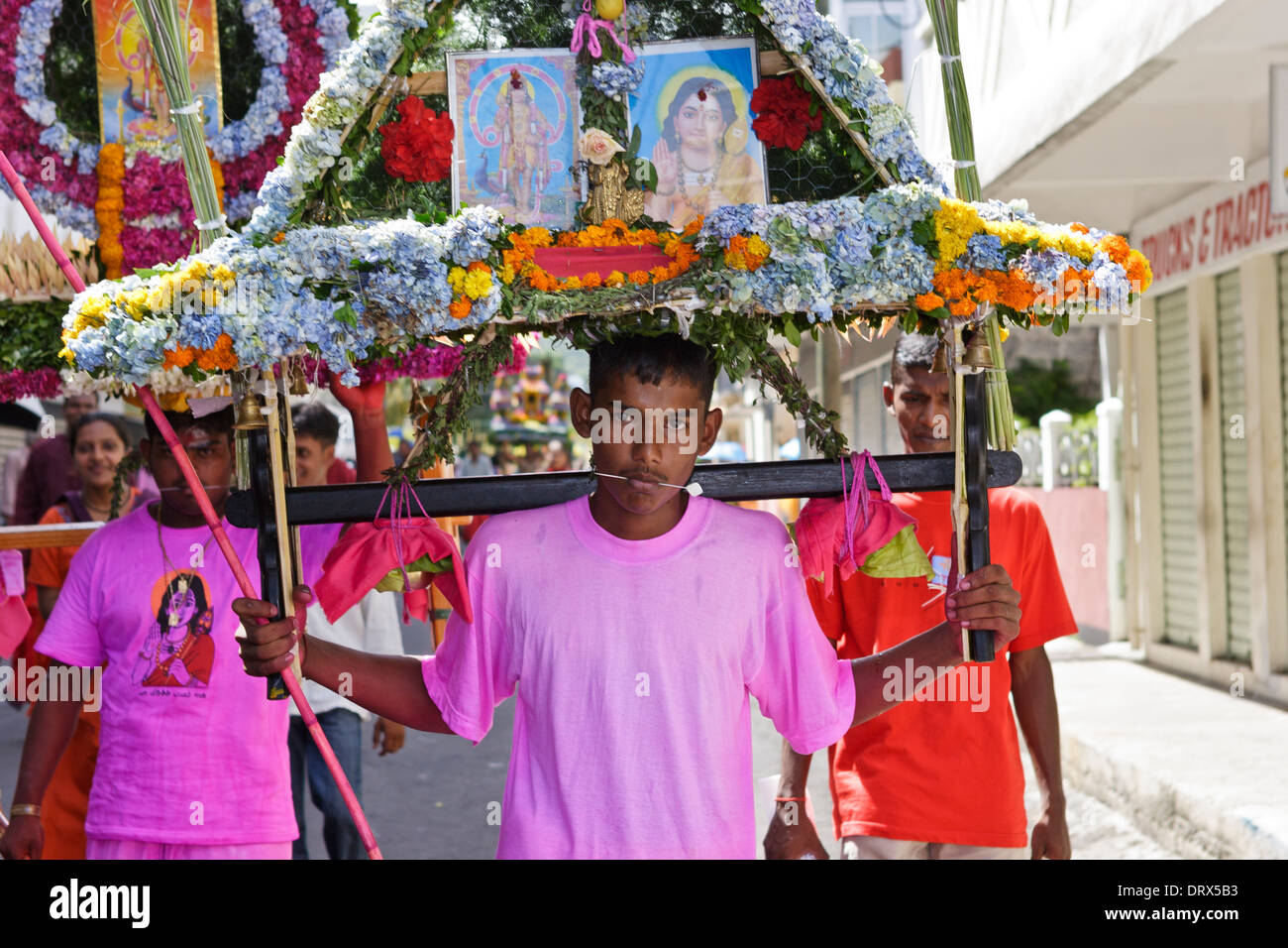 A Tamil devotee of Lord Muruga carrying the Cavadee with his cheeks and ...