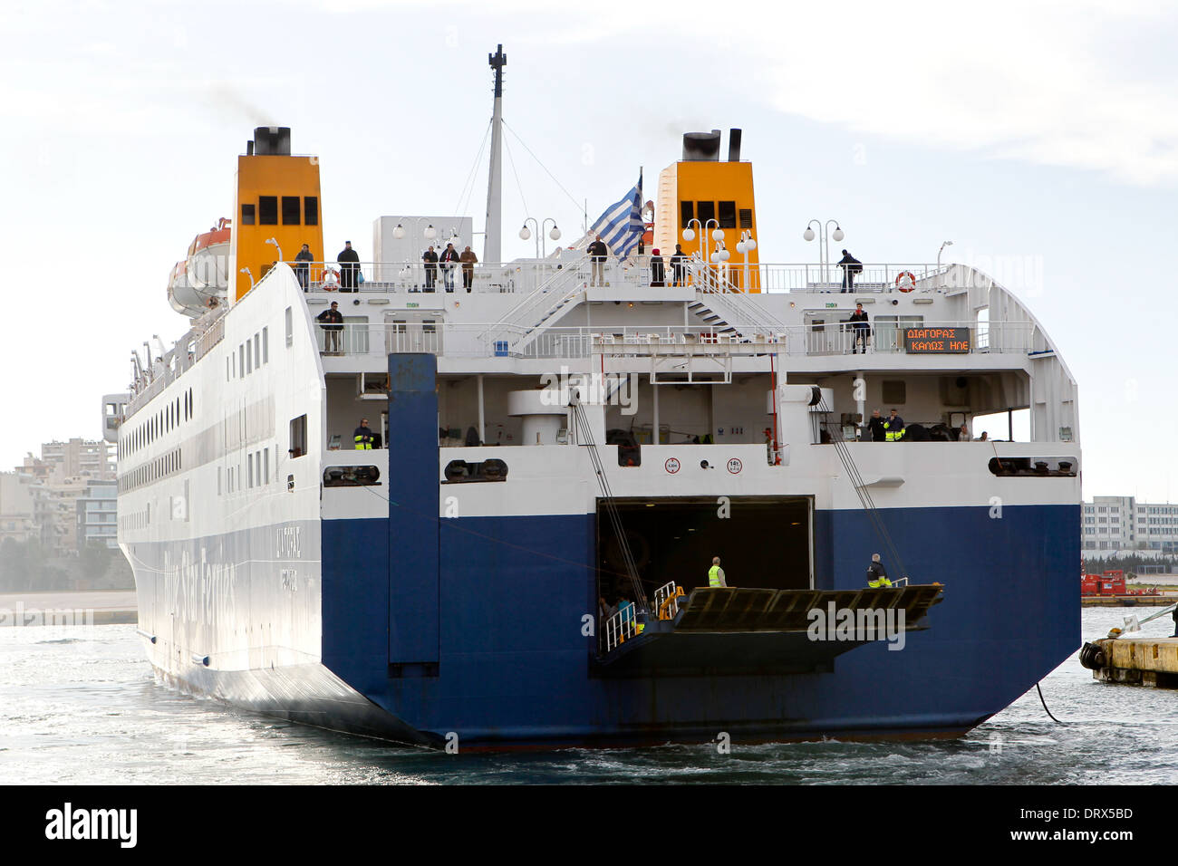 Ship crew guiding heavy duty mooring rope during docking procedure ...