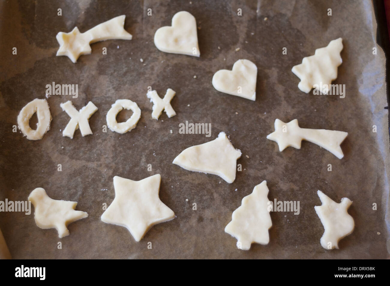 Cut out cookies before baking on a cookie sheet and bake paper Stock ...