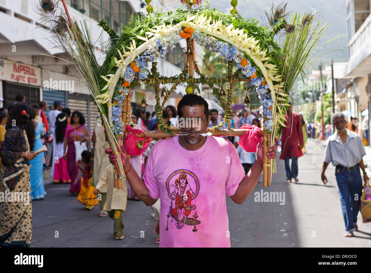 A Tamil devotee of Lord Muruga carrying the Cavadee with his cheeks and ...