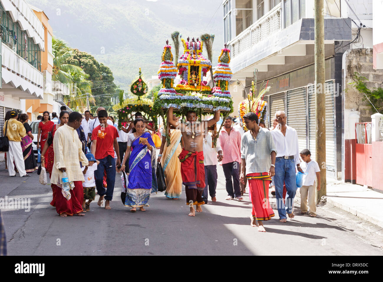 A Tamil devotee of Lord Muruga carrying the Cavadee accompanied by ...