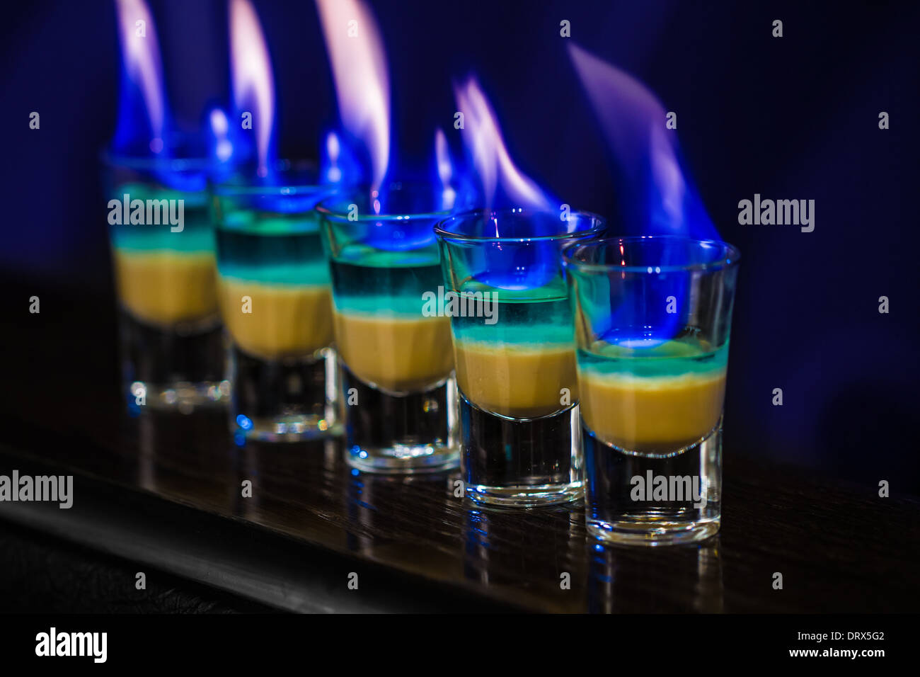 Barman make alcoholic shots in nightclub Stock Photo - Alamy