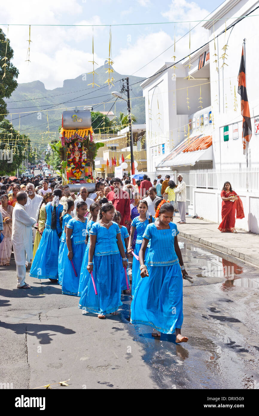 Young female devotees in blue dresses leading the procession of Cavadee ...