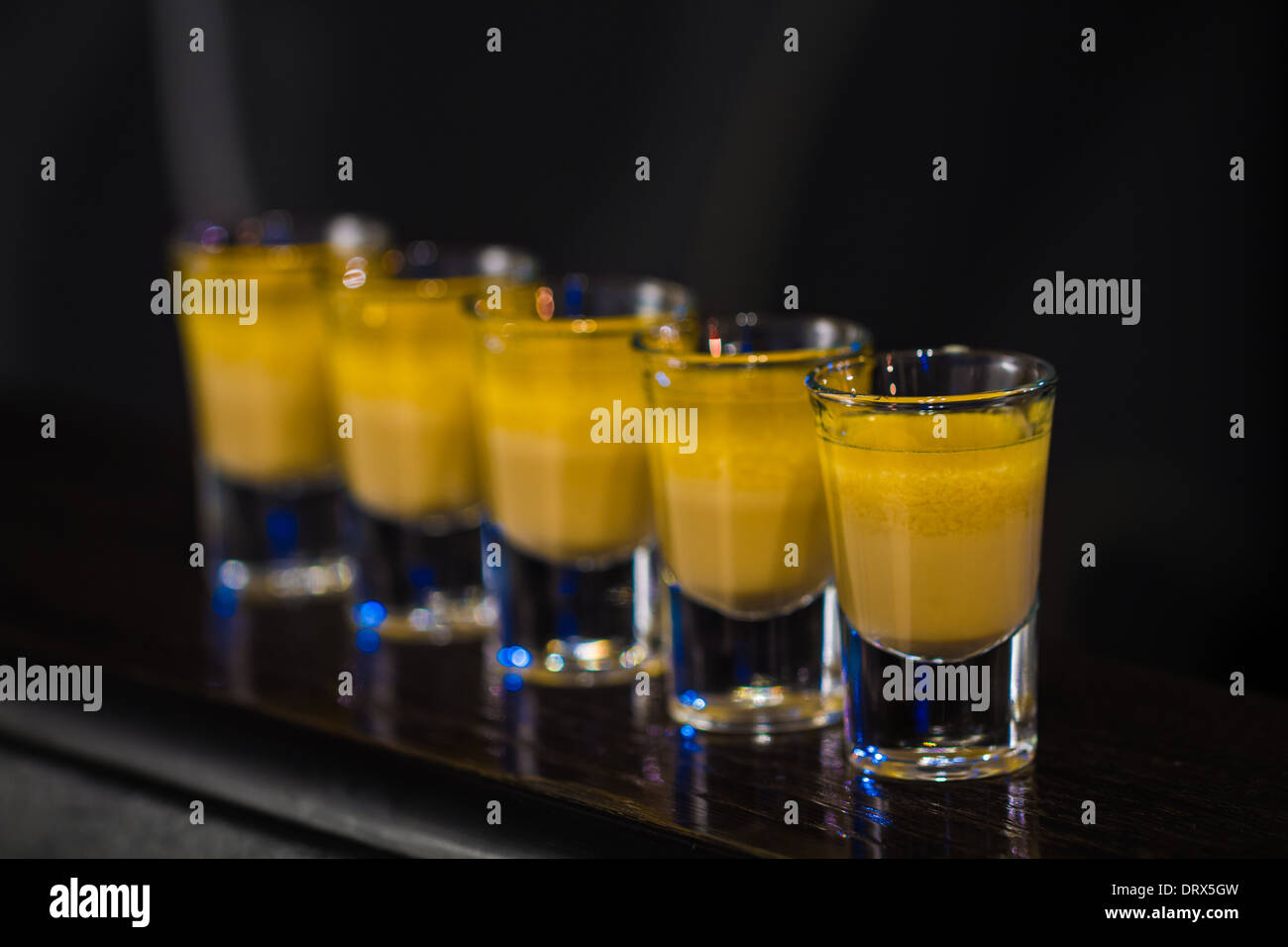 Barman make alcoholic shots in nightclub Stock Photo - Alamy