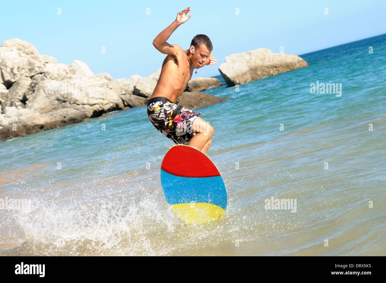 Teenager skimming in the beach Stock Photo - Alamy