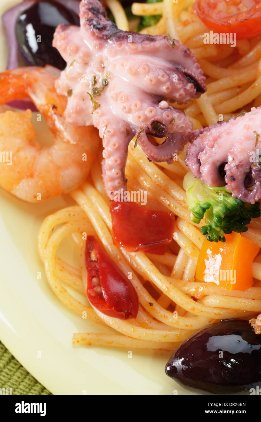 Seafood spaghetti pasta dish with octopus shrimps cherry tomatoes and ...