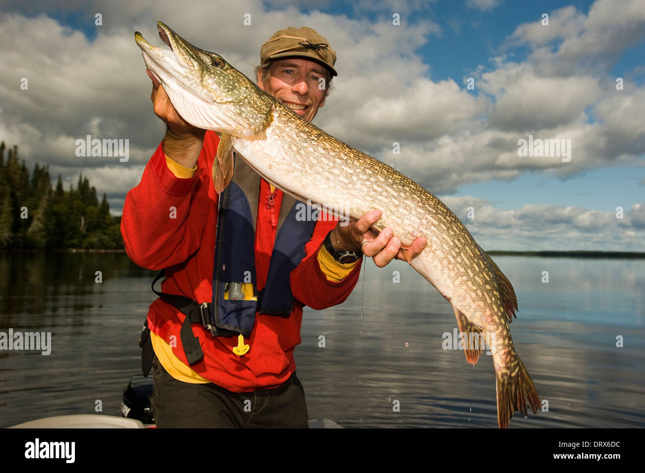 Fisherman holding up a huge northern pike Stock Photo - Alamy