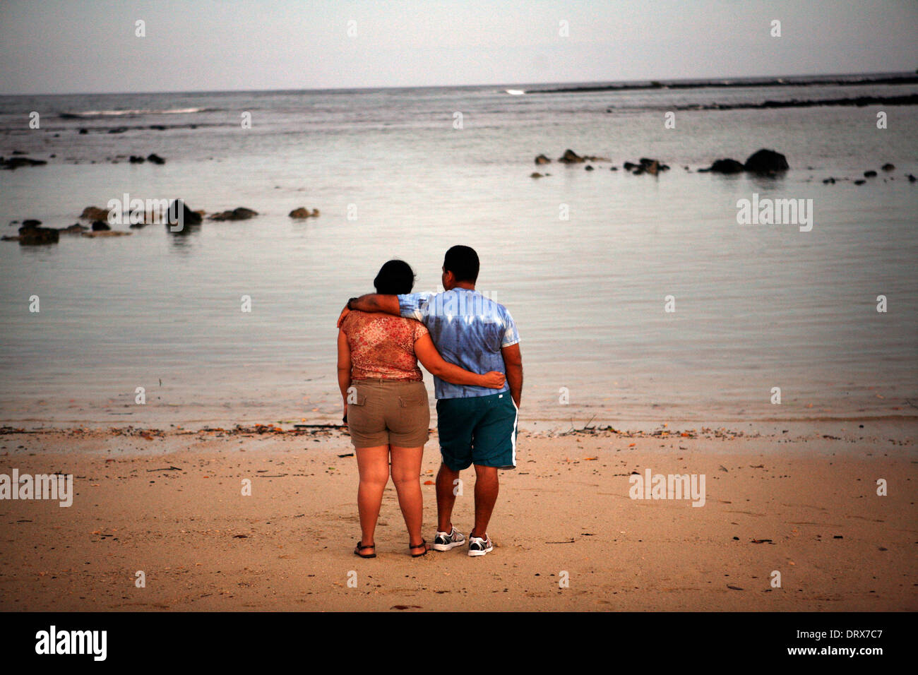 Galapagos Islands. Local residents on the beach at Finch bay after ...