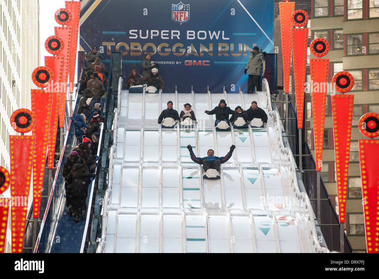 Football fans slide down the 180 foot long, four story high toboggan ...