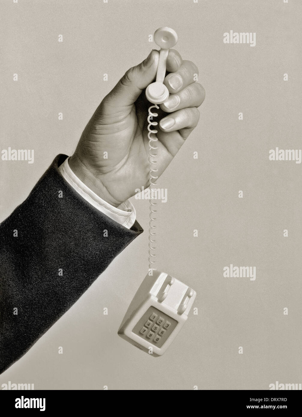 closeup of man with tiny toy phone Stock Photo - Alamy