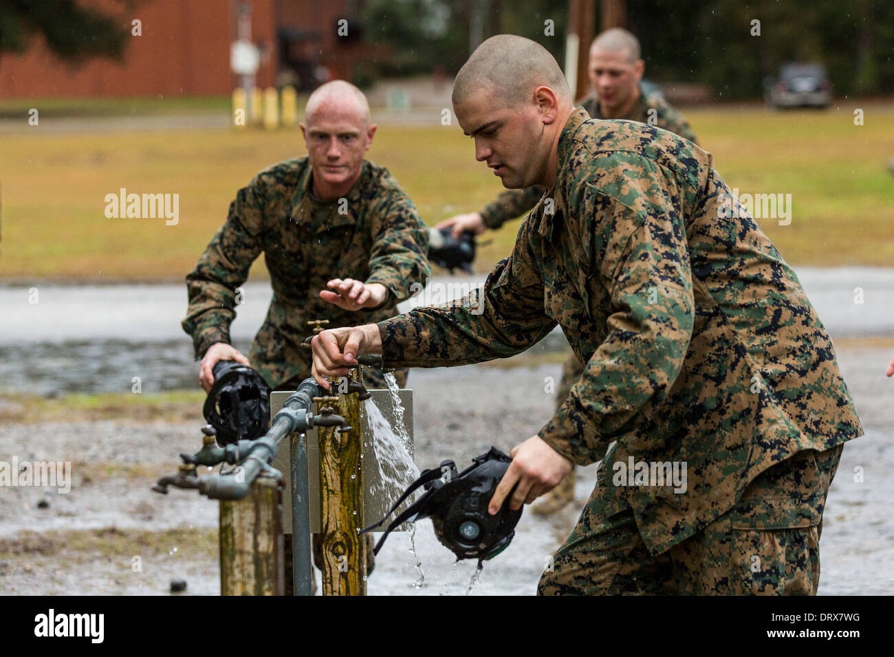 US Marine decontaminate their gas masks after exiting the gas chamber ...