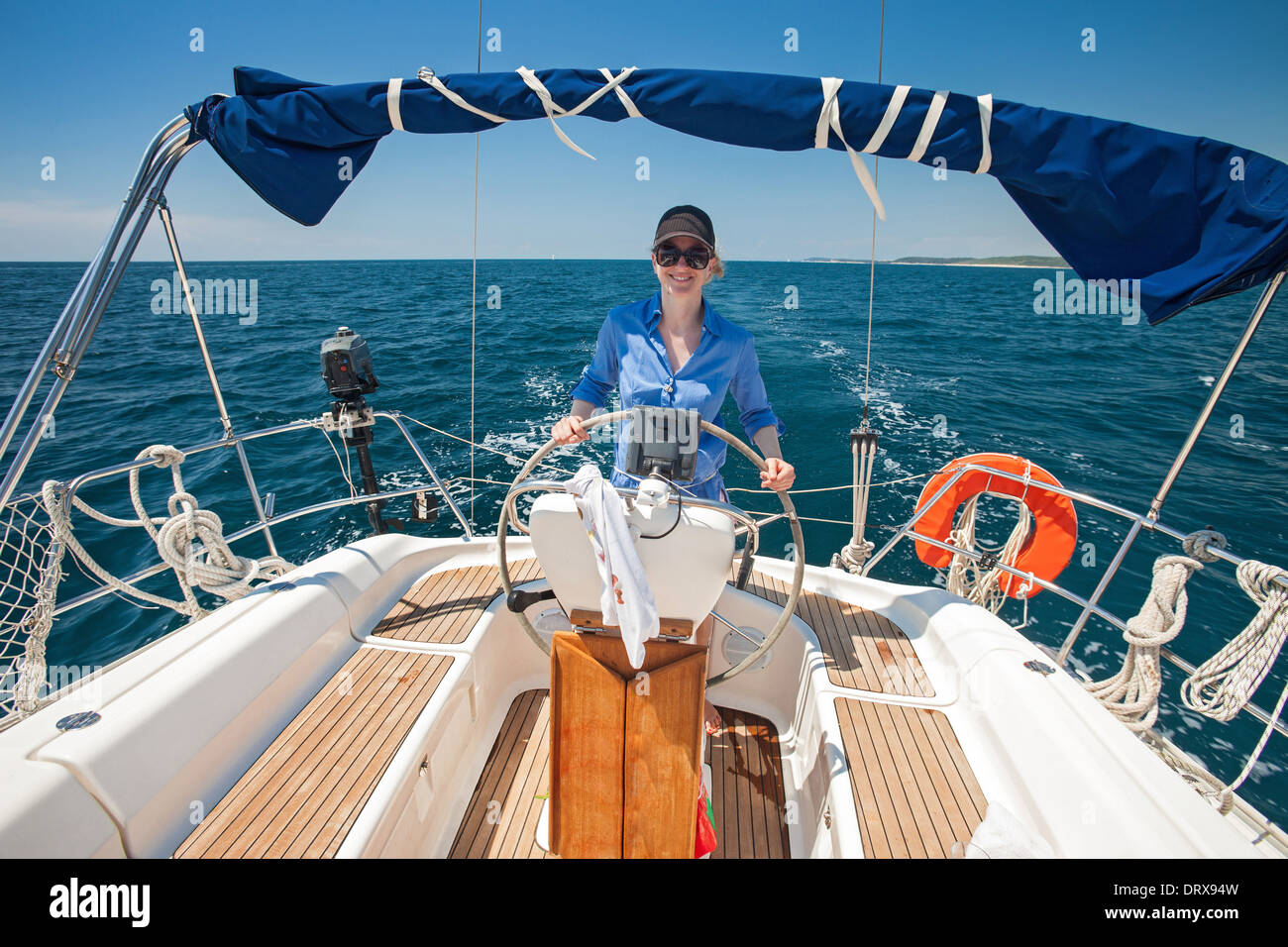 Young woman at helm sailboat hi-res stock photography and images - Alamy