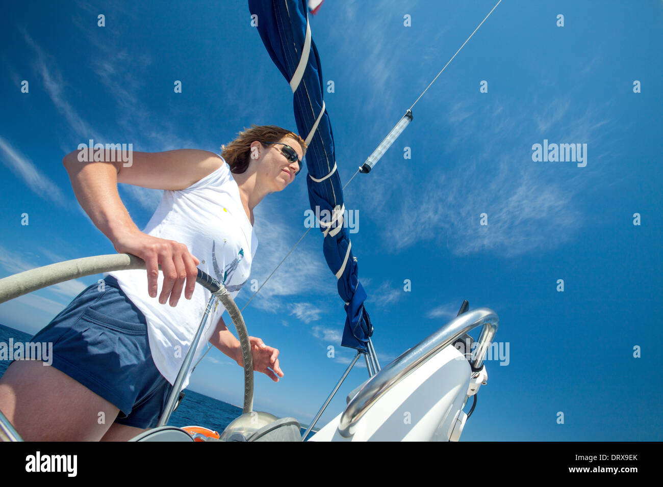 Young woman at helm sailboat hi-res stock photography and images - Alamy