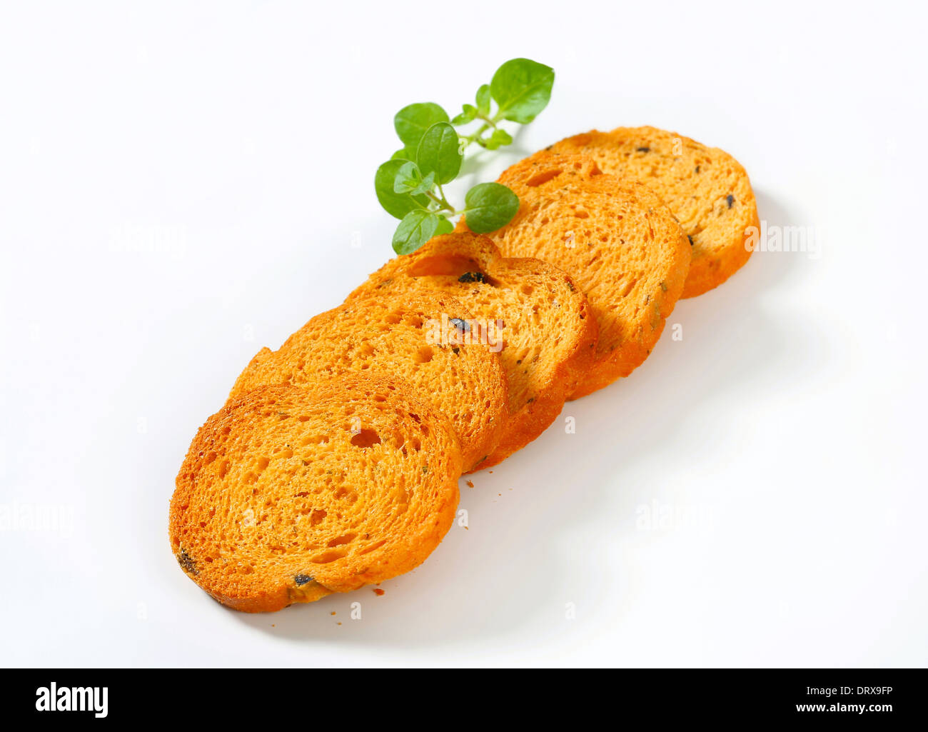 Small round toasts with black olives Stock Photo - Alamy