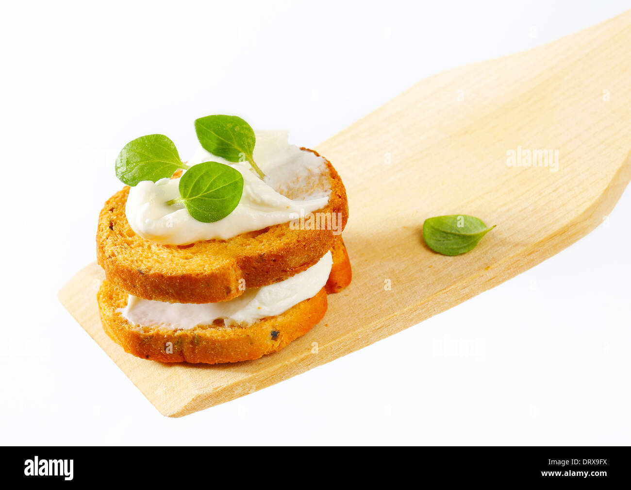 Small round toasts with cheese spread Stock Photo - Alamy