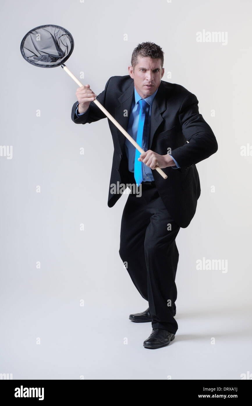 business man holding a fishing net trying to find and catch new ...