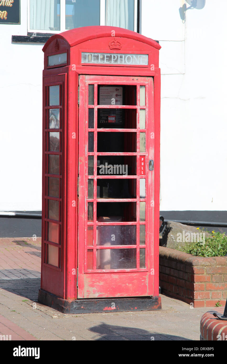 An old red telephone box with several broken panes of glass Stock Photo ...