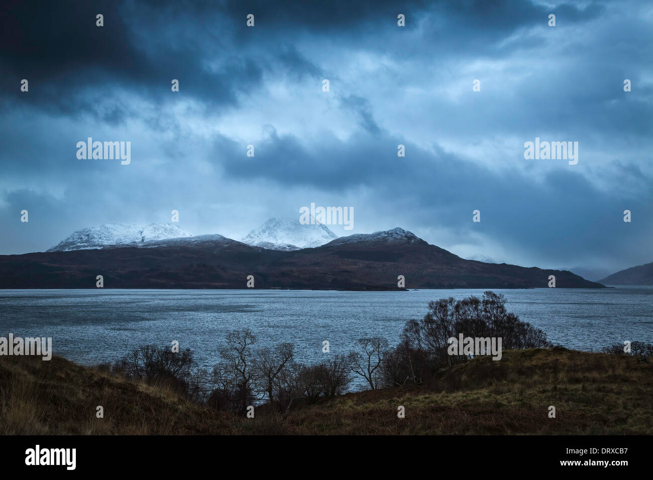 Snow covered summit of Beinn Sgritheall across the Sound of Sleat, Isle ...