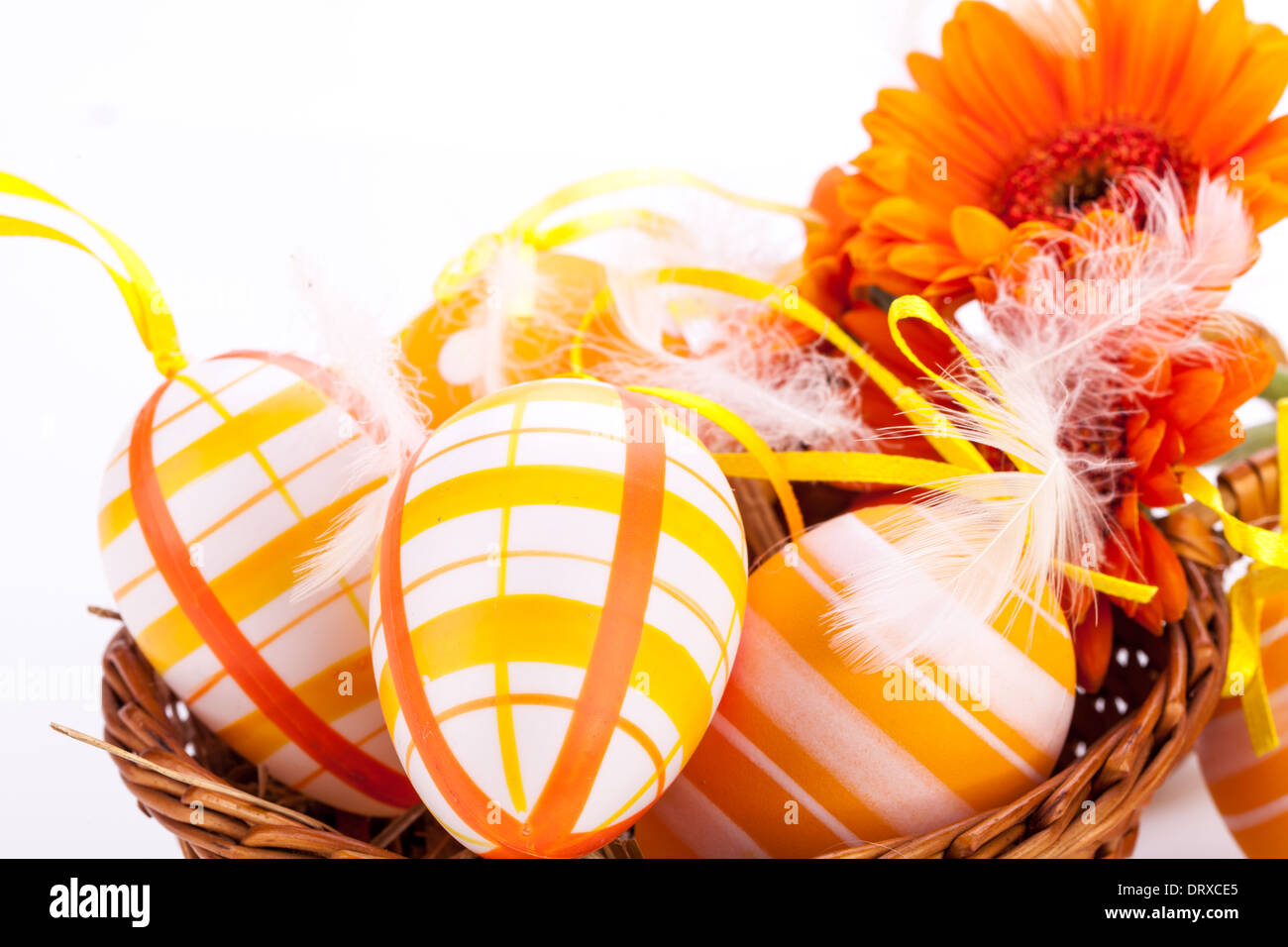 Colourful yellow hand decorated traditional Easter eggs with stripes and polka dot patterns ...