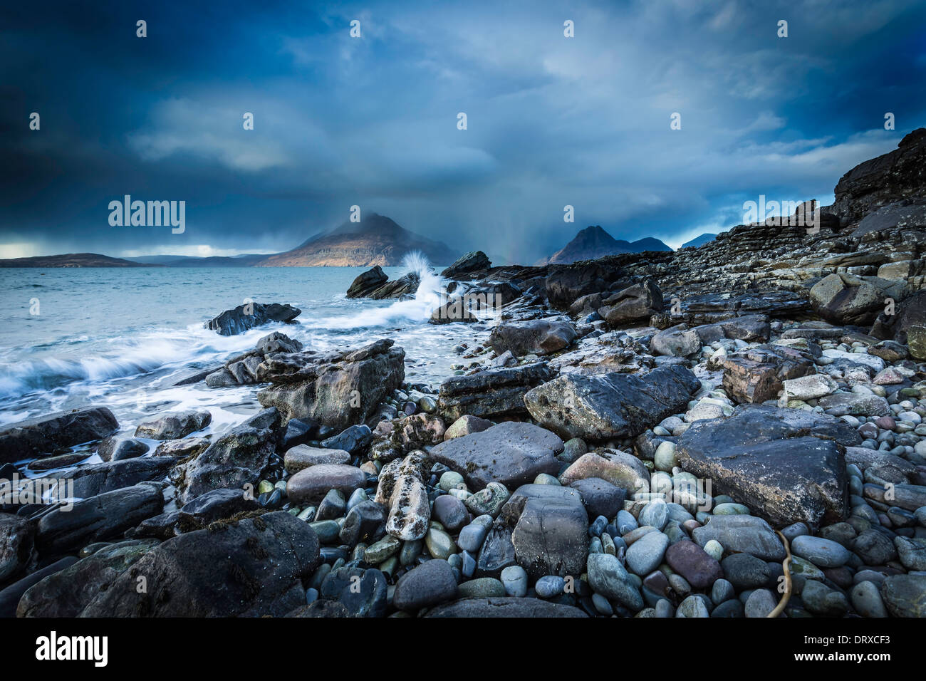Storm clouds and rain squalls over the Cuillins with the beach at Elgol ...
