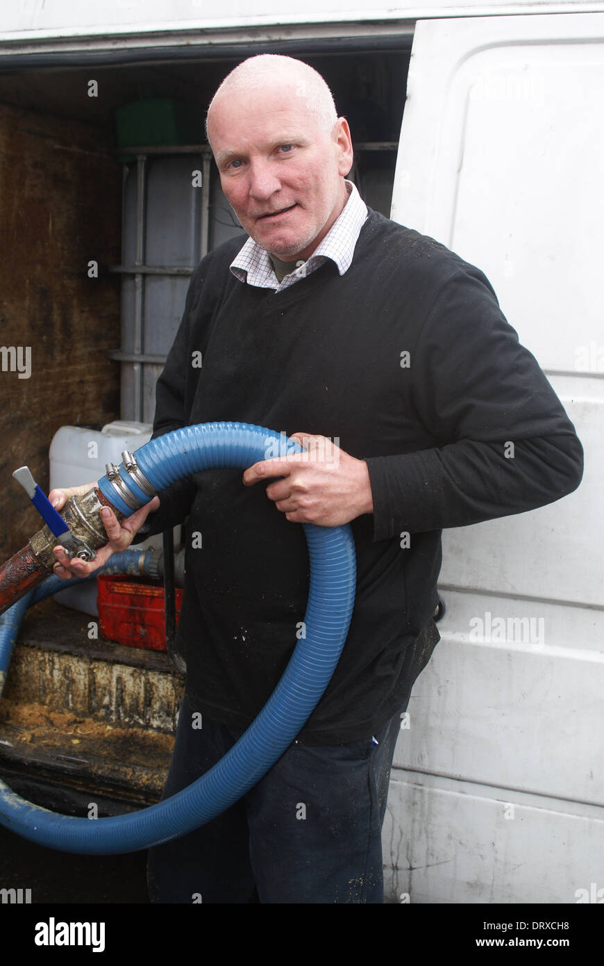 man with hose to pump biofuel Stock Photo - Alamy