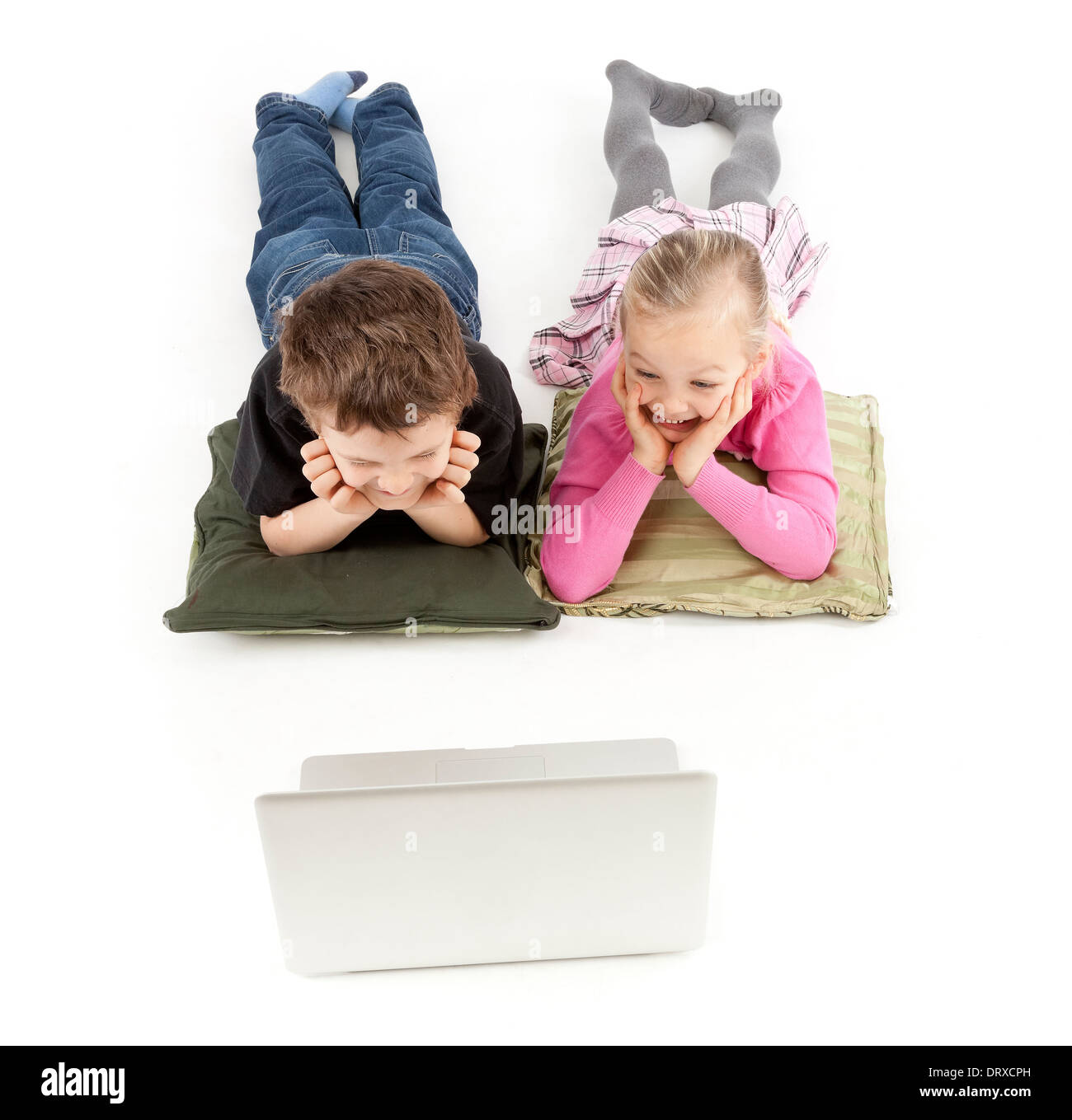 Children are lying and watching the silver Notebook Stock Photo - Alamy