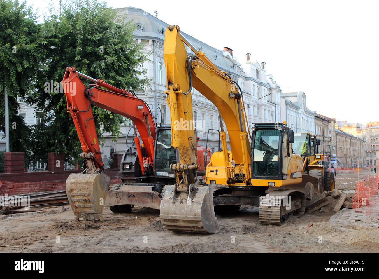 two modern and big excavators working on the Lvov street Stock Photo ...
