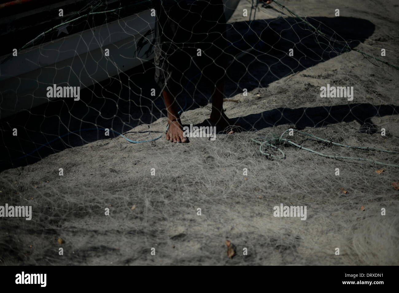 Chame, Panama. 3rd Feb, 2014. A fisherman fixes his net after going ...