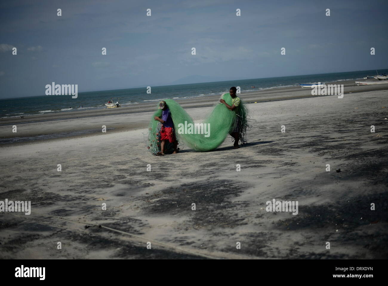 Chame, Panama. 3rd Feb, 2014. Fishermen fix their nets after going ...