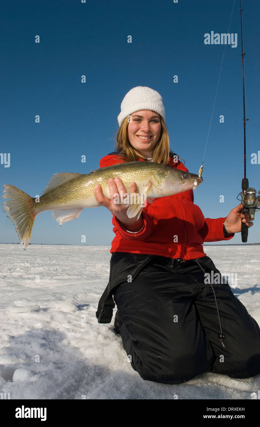 A young girl holds up a winter walleye she caught ice fishing Stock ...