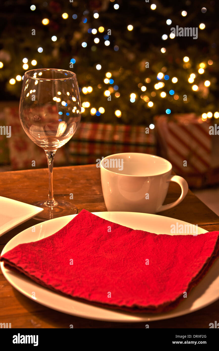 Christmas dinner plate setting in front of Christmas Treec Stock Photo ...