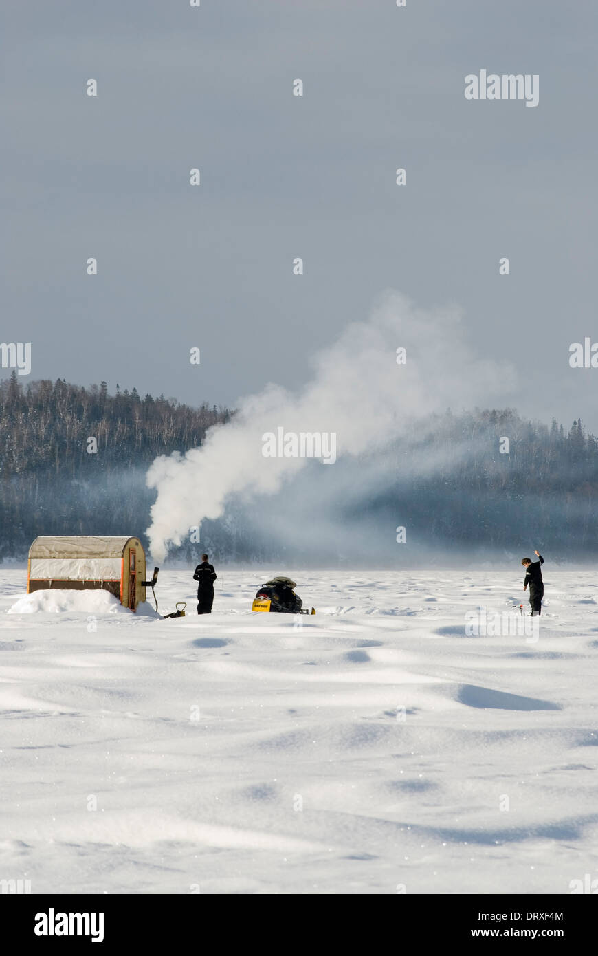 Ice fishermen fishing on a frozen lake near their hut Stock Photo - Alamy