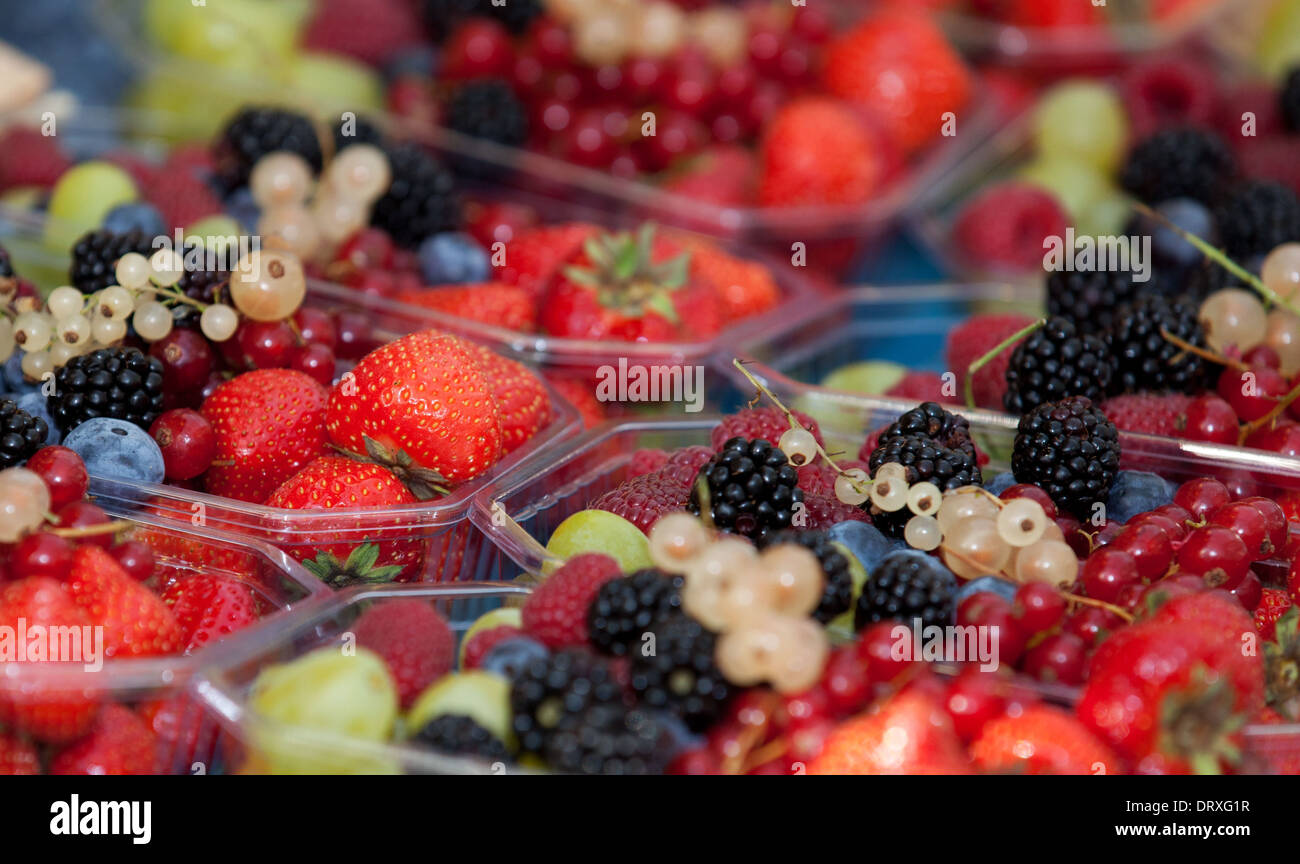 Market stall offering boxes with wild berries Stock Photo - Alamy
