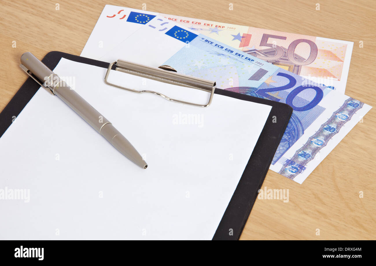 70 euro lying next to clipboard Stock Photo - Alamy