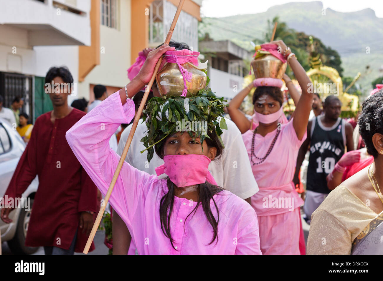 Two female devotees to Lord Muruga carrying a pot of sacred milk on her ...