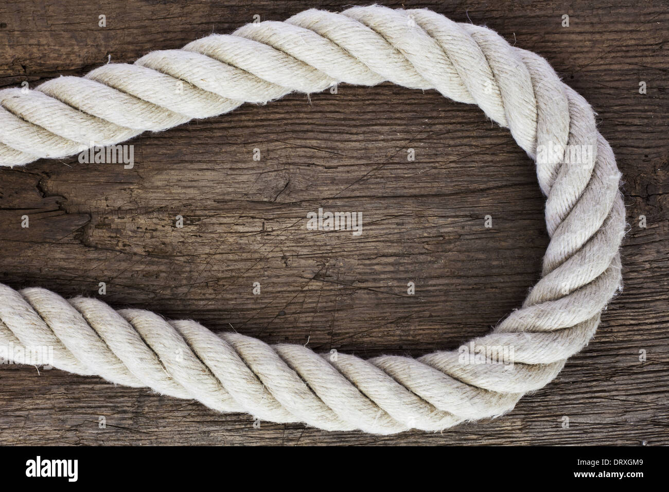 Heavy rope on wooden background concept Stock Photo - Alamy