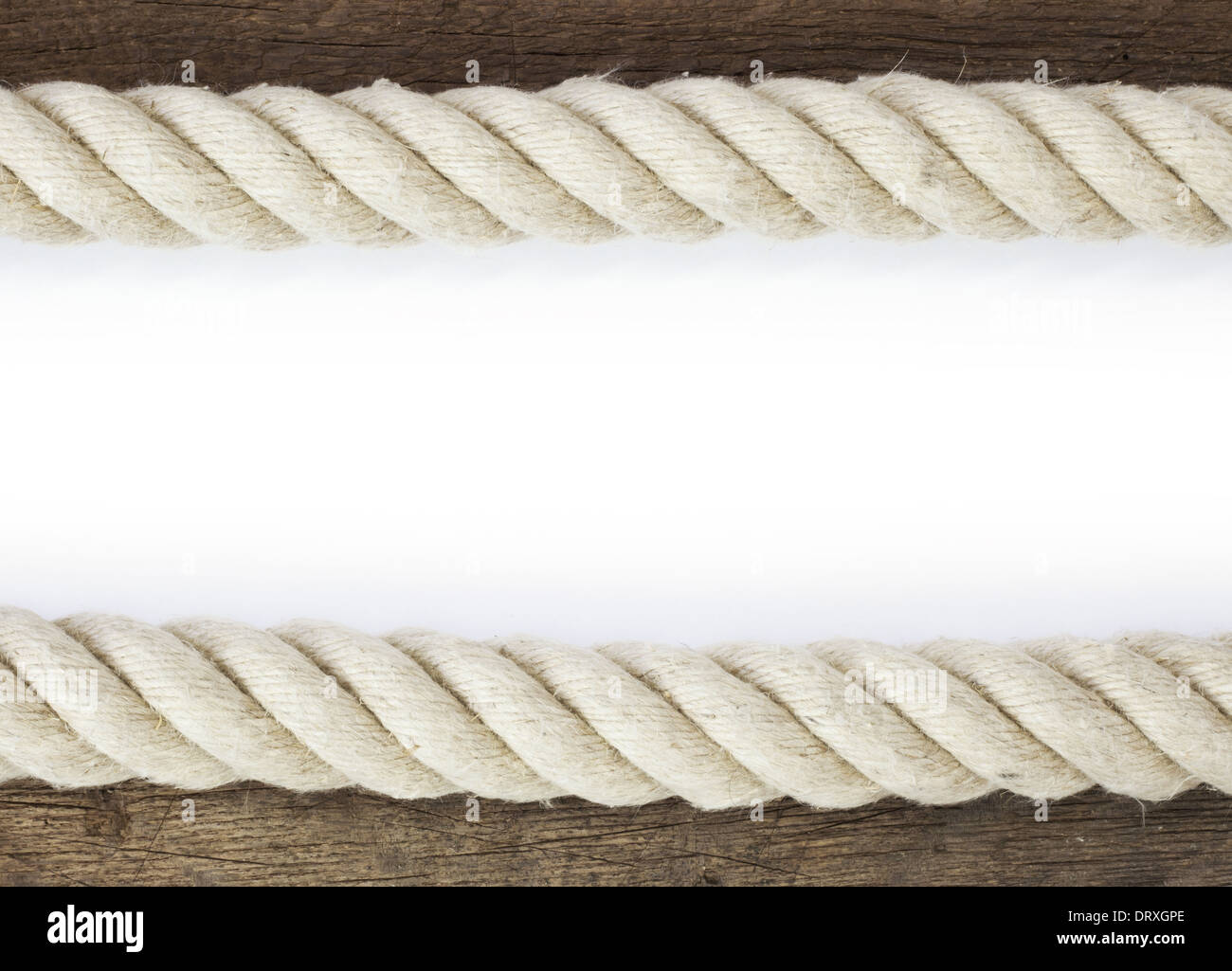 Heavy rope on wooden board. All on white background Stock Photo - Alamy