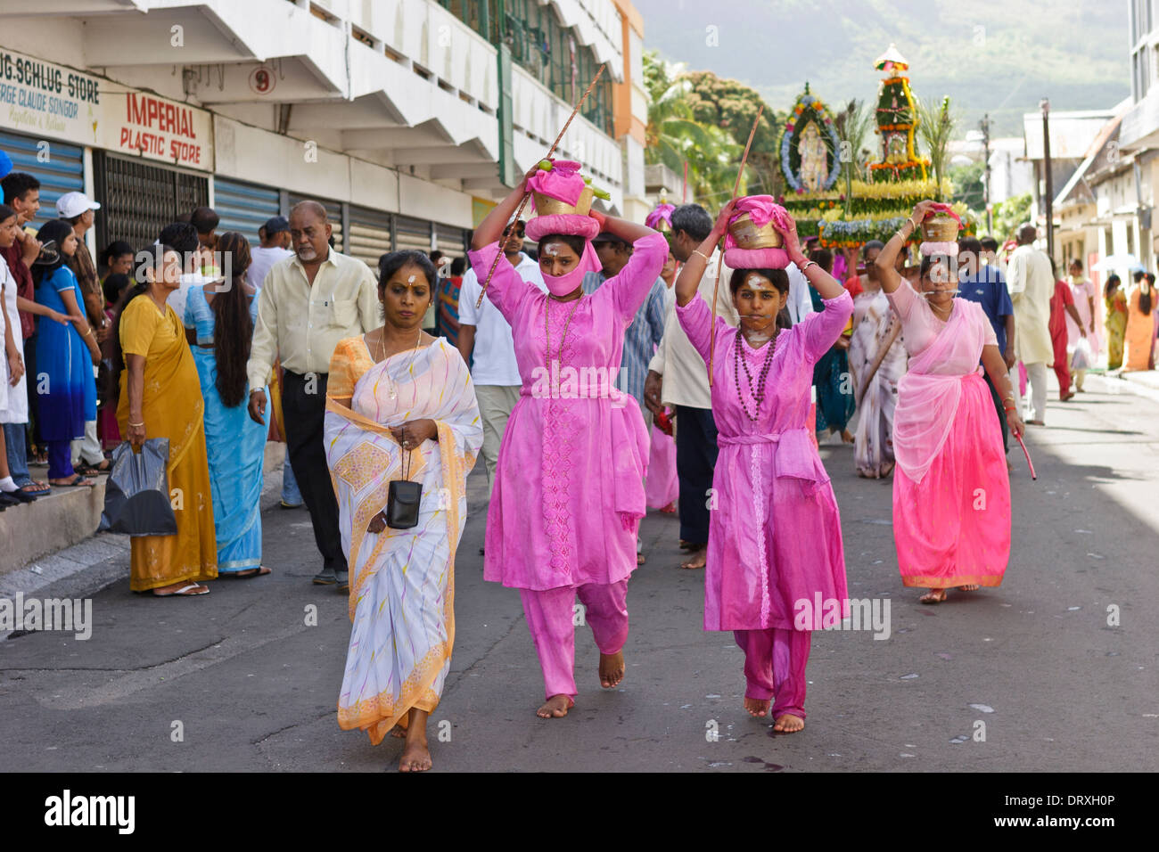 Women carrying pot of sacred milk and mouth covered as vow of silence ...