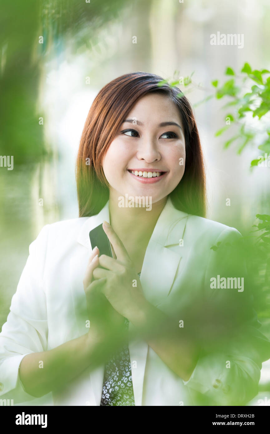 Asian Businesswoman using a smart phone. Happy smiling Chinese business ...