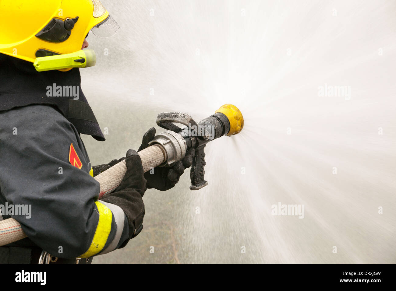 fireman fighting fire Stock Photo - Alamy