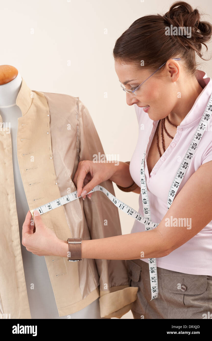 Female fashion designer taking measurement Stock Photo - Alamy