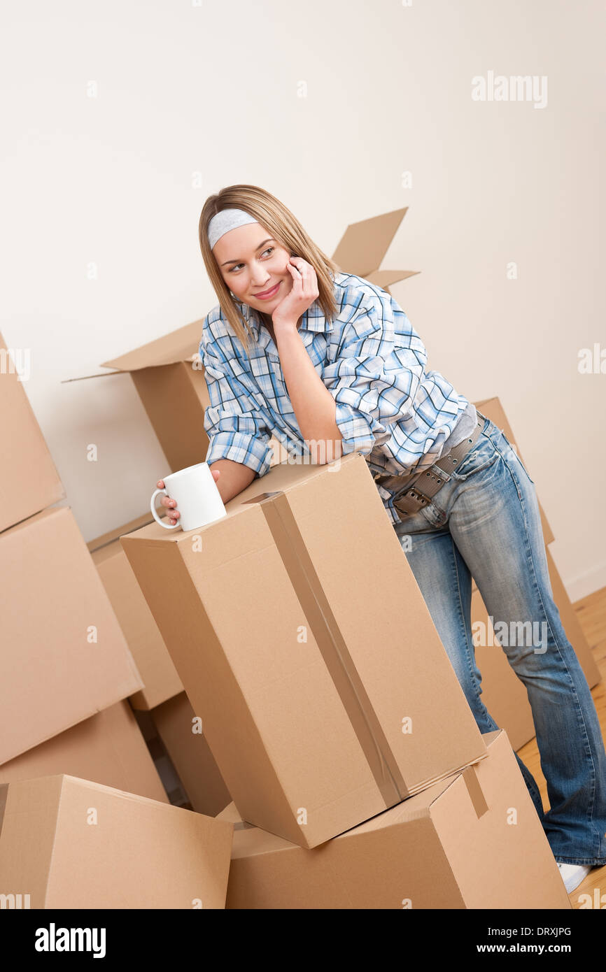 Moving house: Woman with box in new home Stock Photo - Alamy