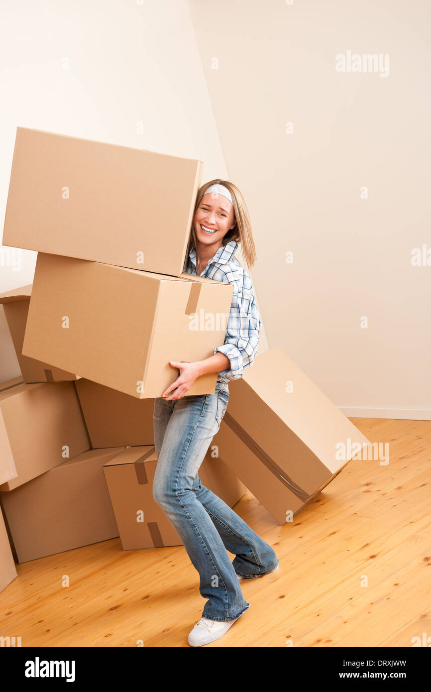 Moving house: Woman holding heavy carton box Stock Photo - Alamy