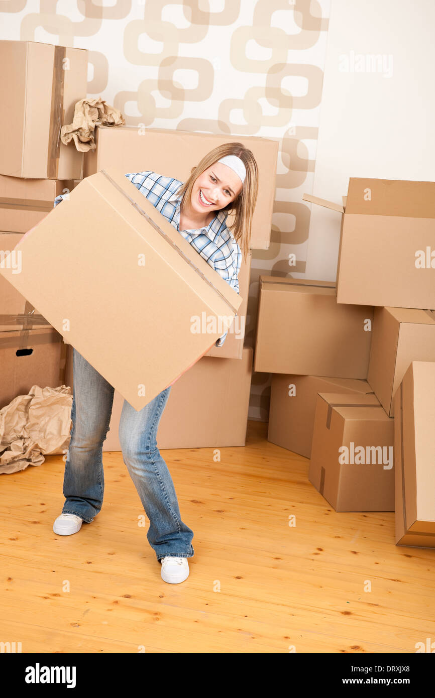 Moving house: Woman holding big carton box Stock Photo - Alamy