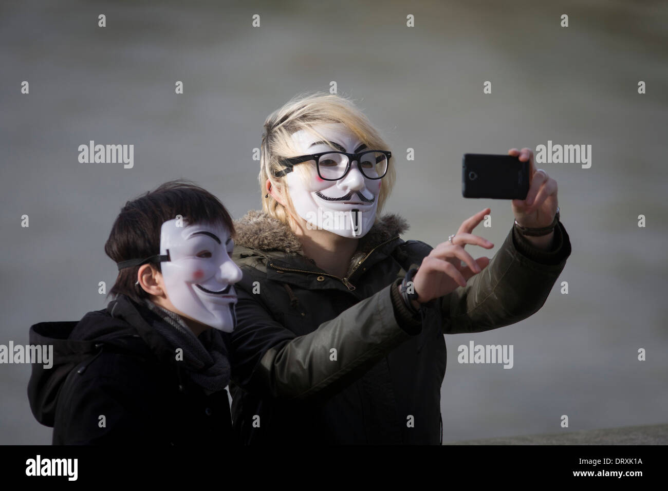 A couple wearing Anonymous masks pose for their own selfie photo Stock ...