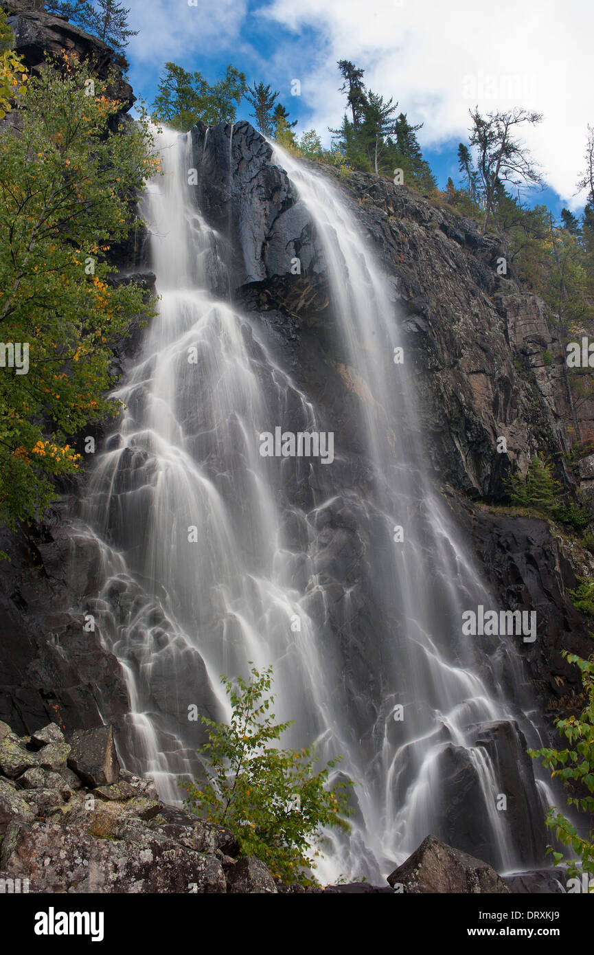 A natural waterfall cascades off a forest cliff Stock Photo - Alamy