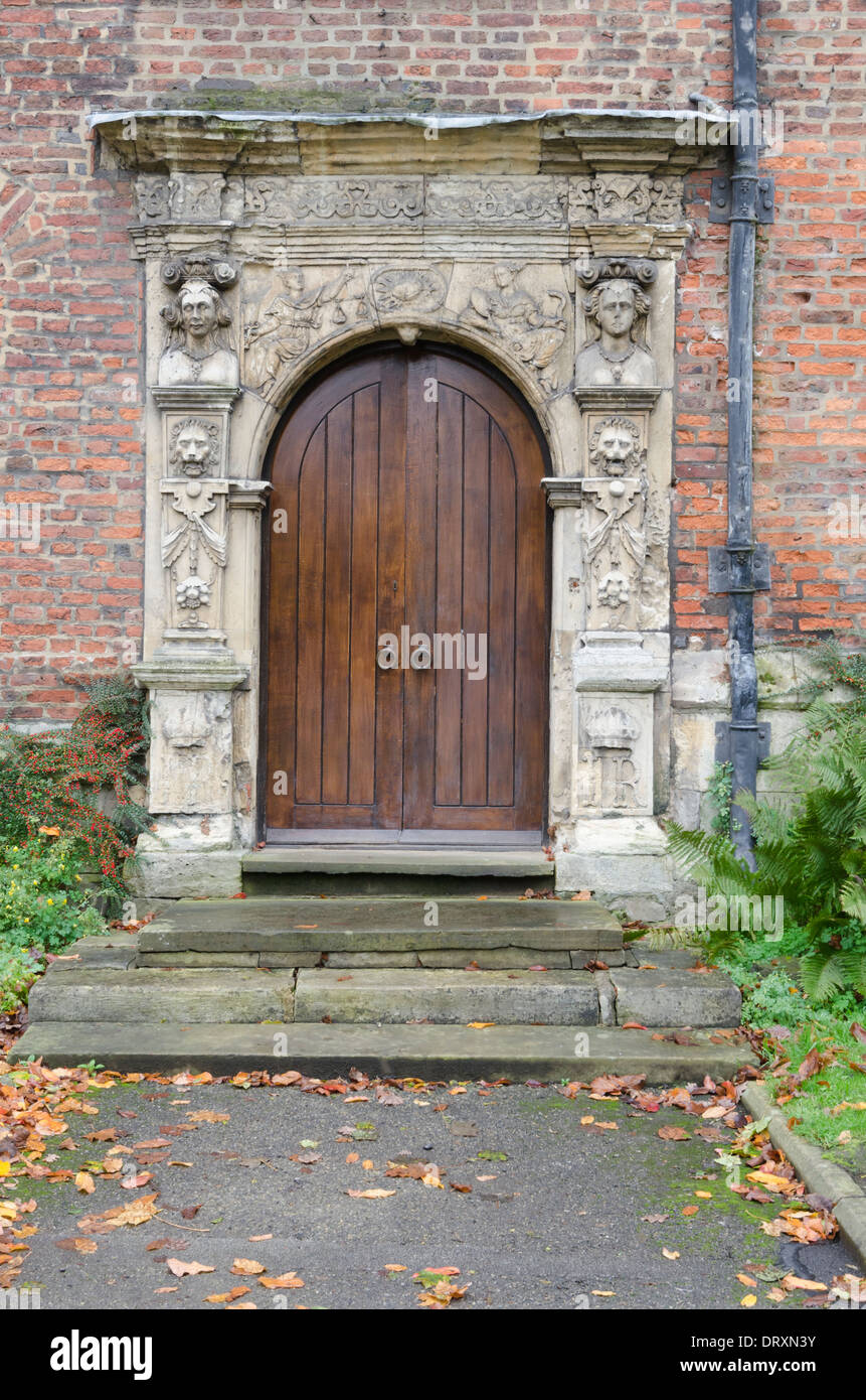 A wooden door in a decorated stone frame in York Stock Photo - Alamy